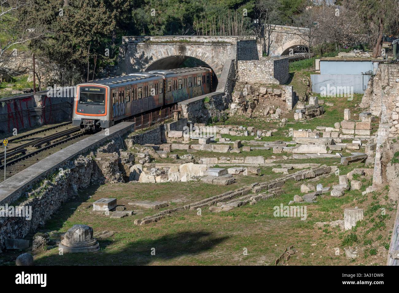 The train passes through the ancient Agora of Athens, Greece, passing ...