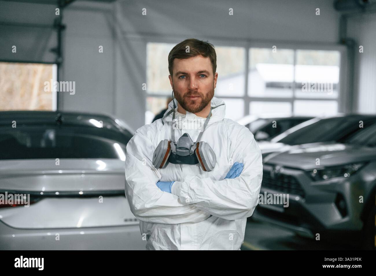 Portrait of professional painter with mask that is standing in the ...