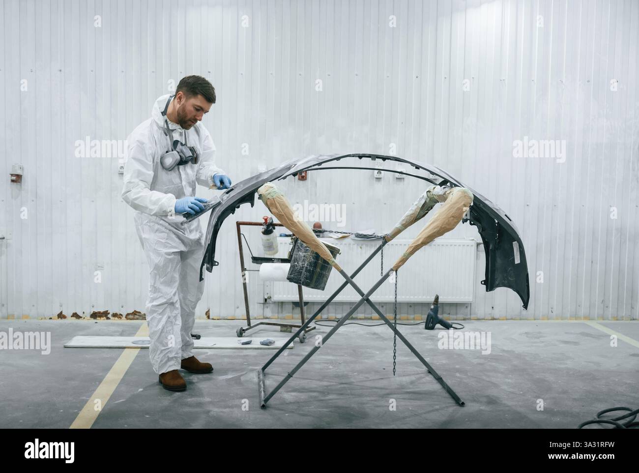 Unfinished part. Repairman is working with carcass of the car in the ...