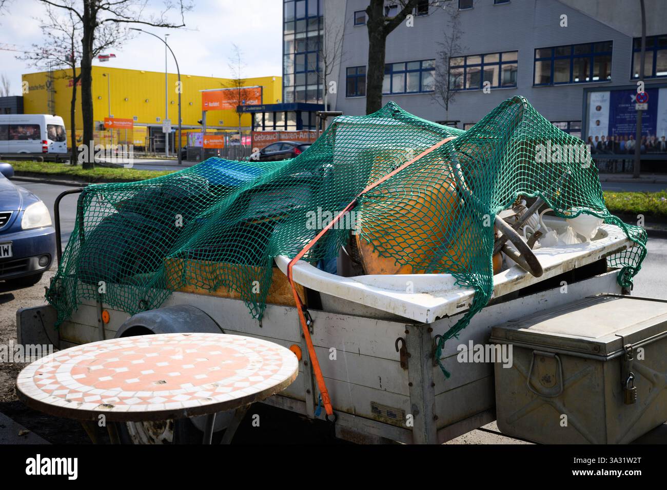 14 March 2025, Berlin: Bulky waste waits opposite the entrance to the ...