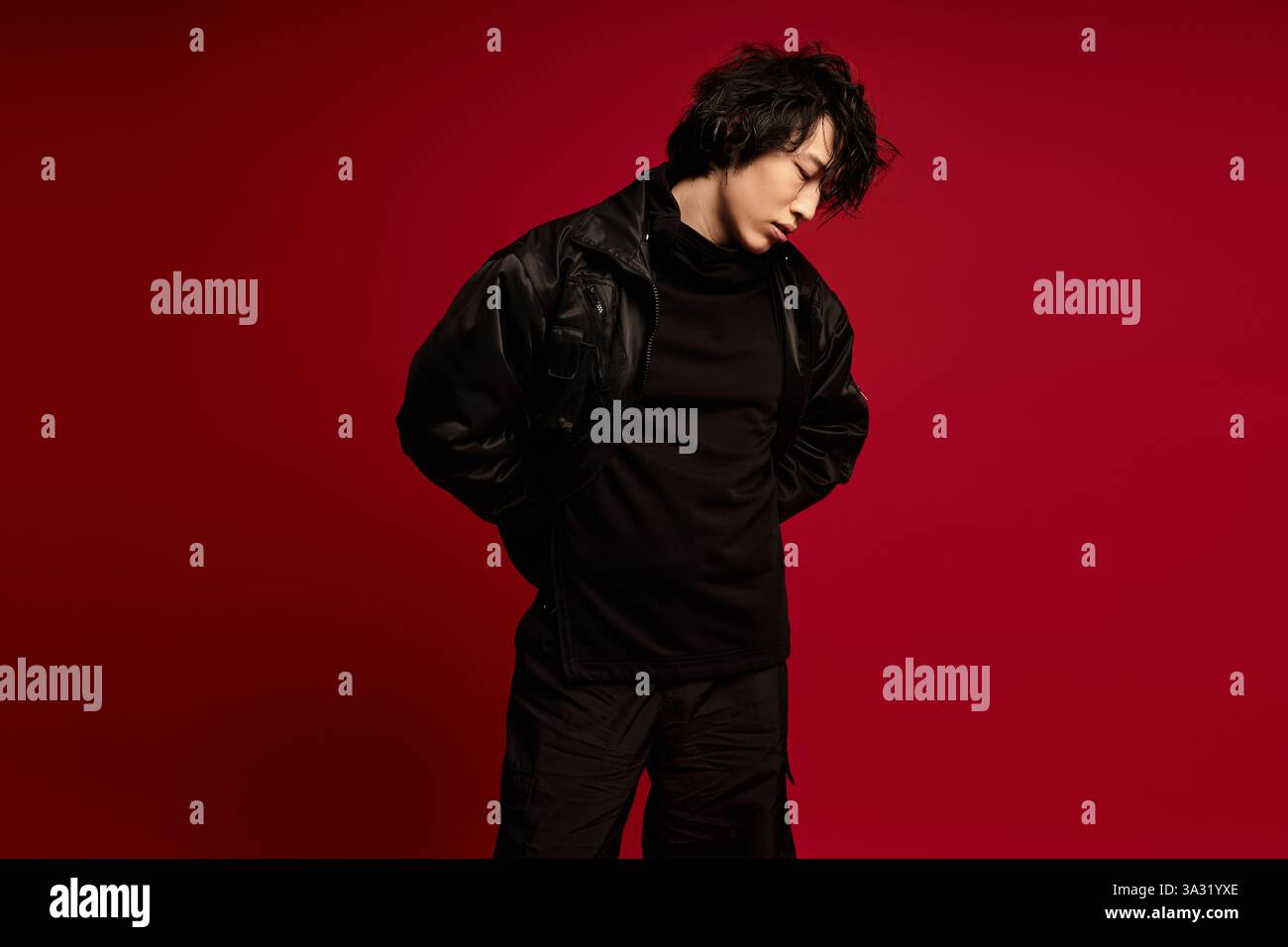 A handsome young asian man is in a studio with red background Stock ...