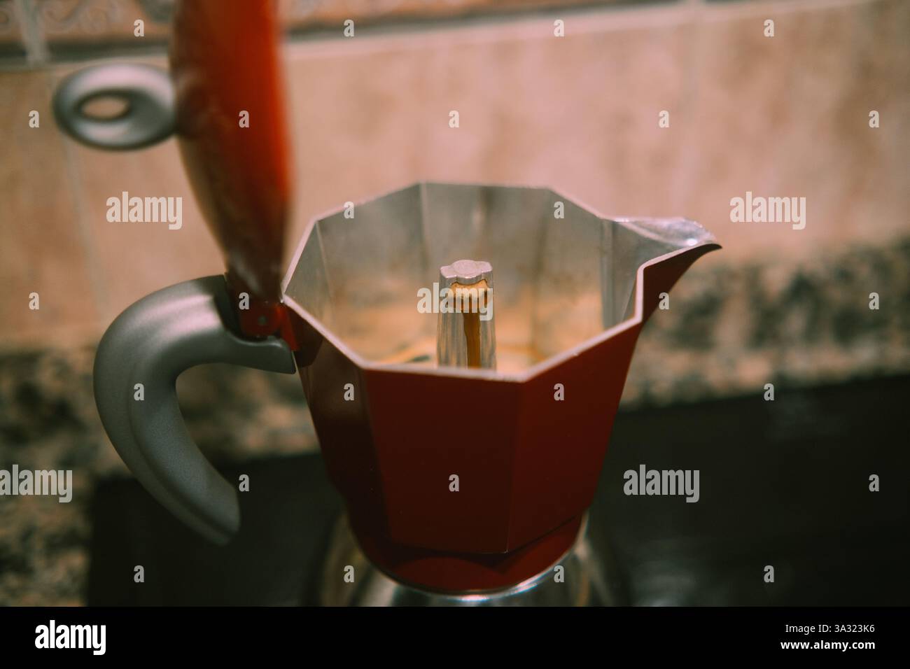 Brewing red moka coffee at home Stock Photo - Alamy