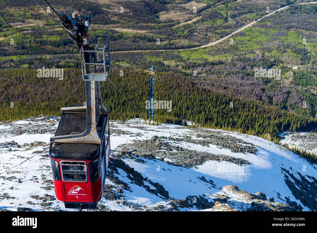 Jasper SkyTram aerial tramway ascending the snow-capped Rocky Mountains ...