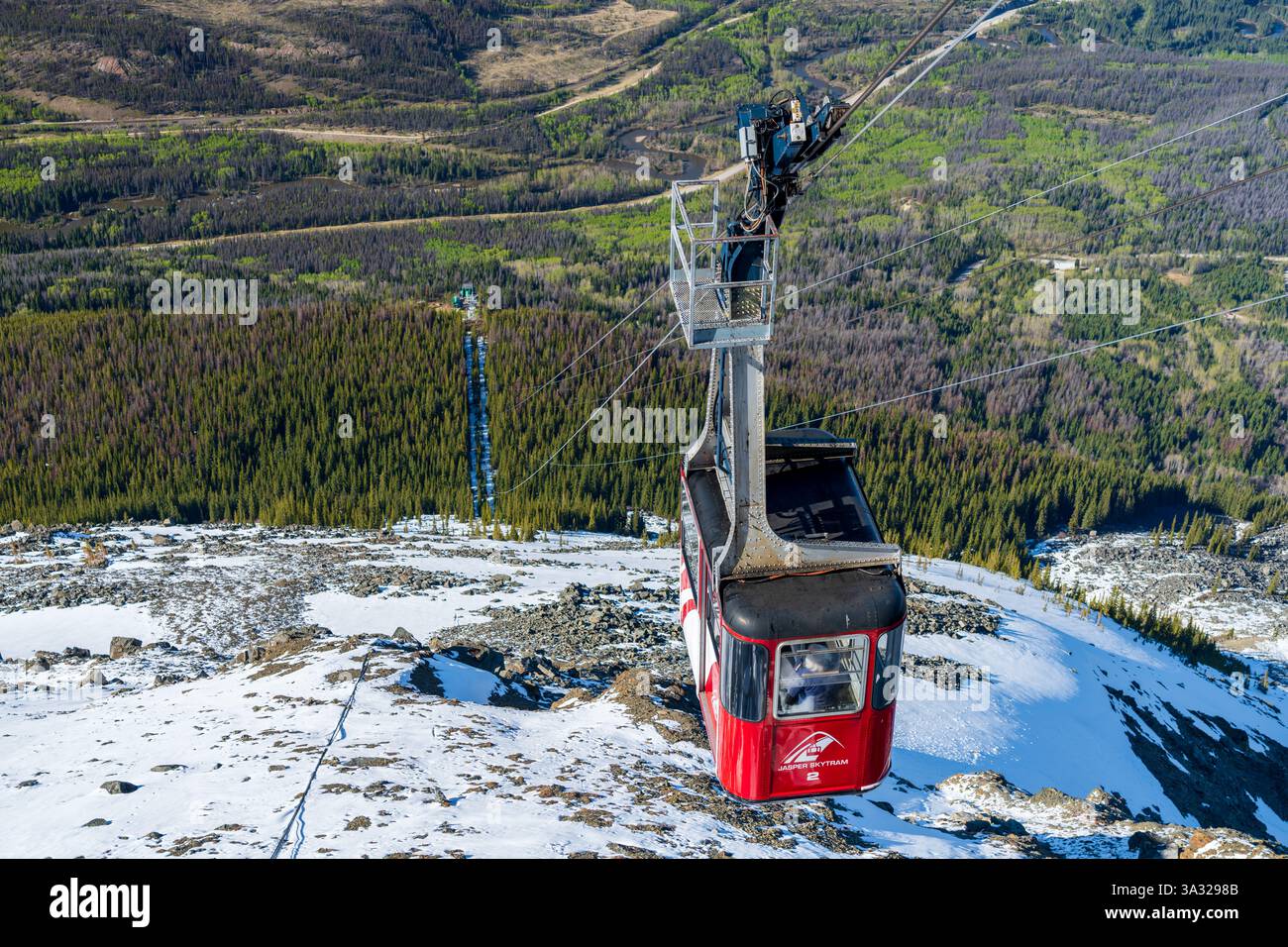 Jasper SkyTram aerial tramway ascending the snow-capped Rocky Mountains ...