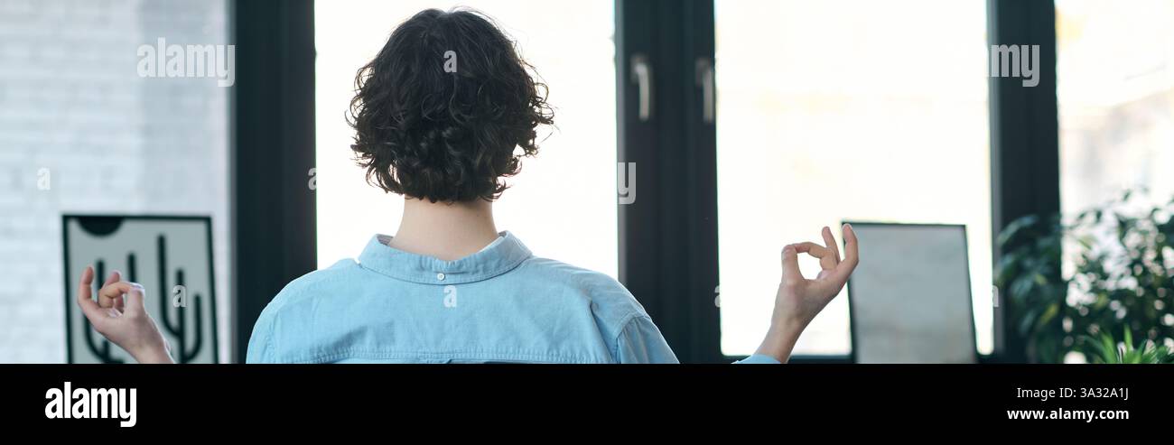 A handsome young professional sits calmly in an office, practicing ...