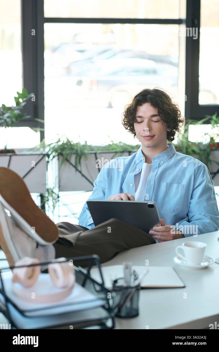 Young professional sitting comfortably kitchen hi-res stock photography ...