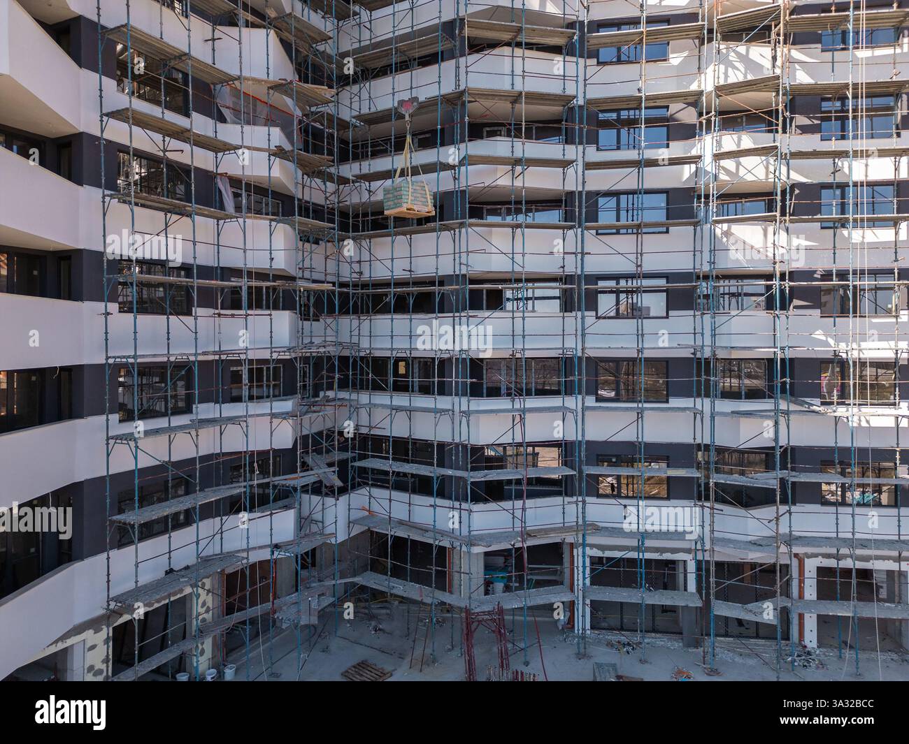Construction progress of a modern residential building with scaffolding ...