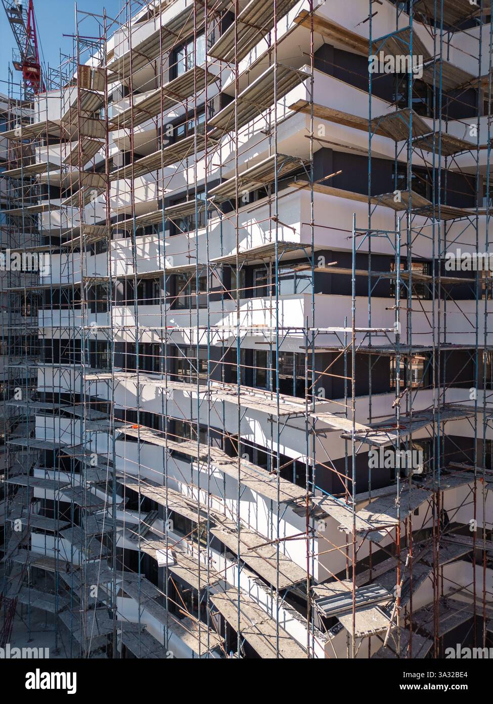 Construction progress of a modern residential building with scaffolding ...