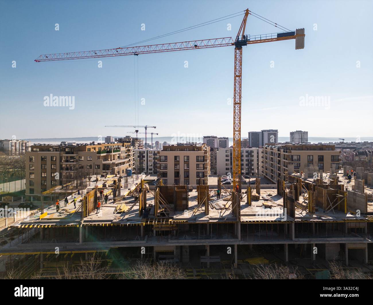 Aerial view of a cityscape with ongoing construction projects and completed residential ...