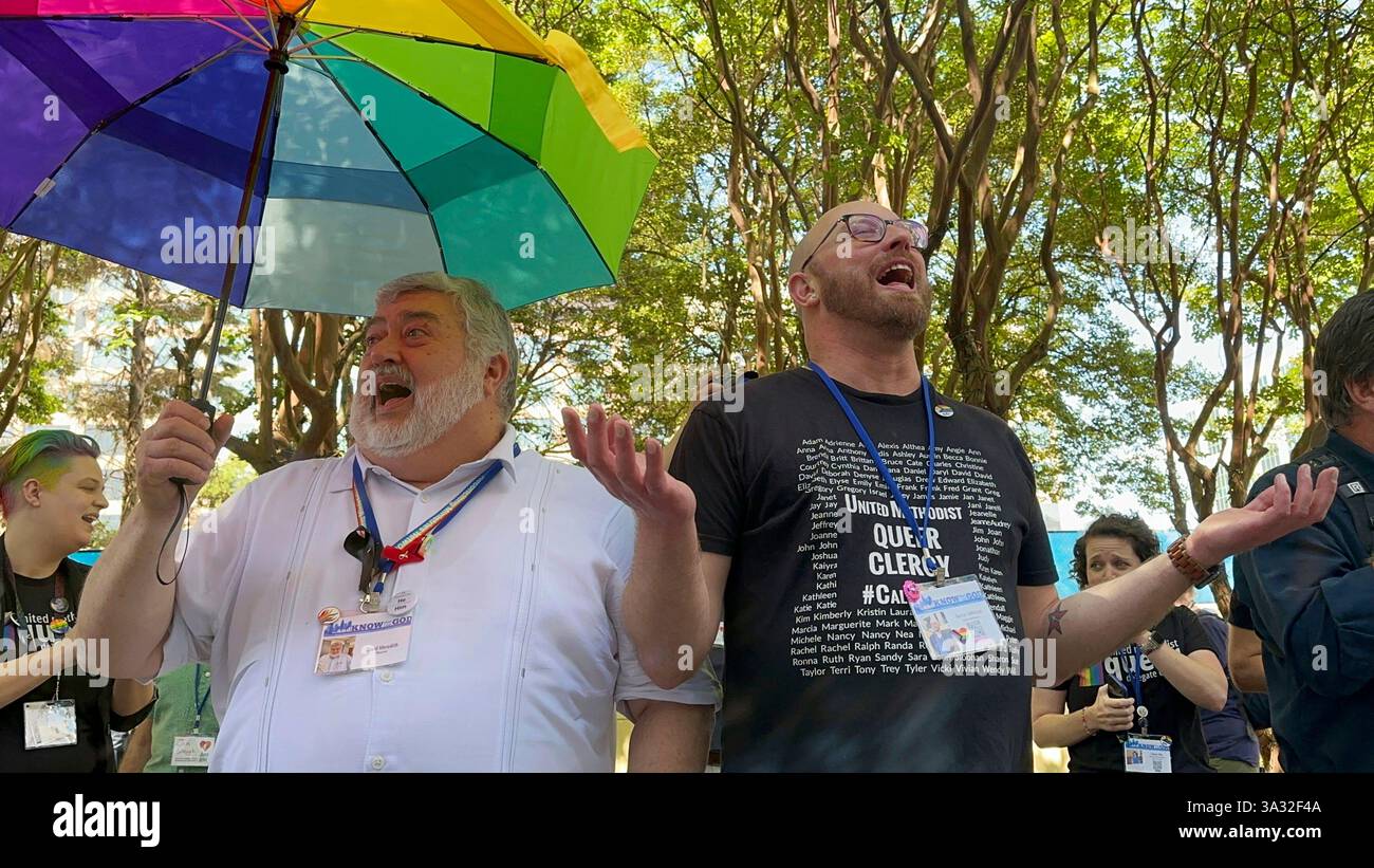 FILE - The Rev. David Meredith, left, and the Rev. Austin Adkinson sing ...