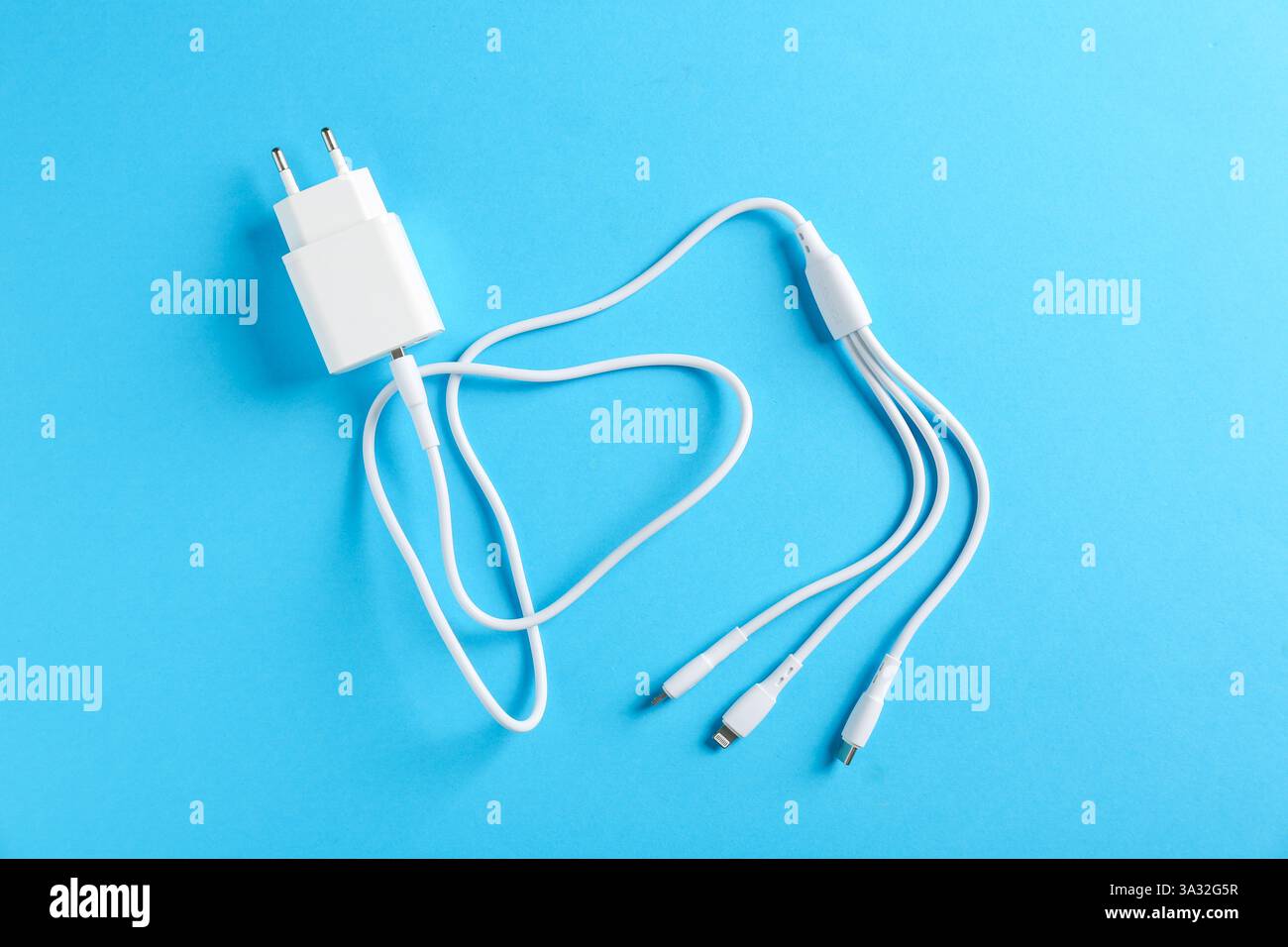 USB power adapter with triple charge cable on light blue background ...