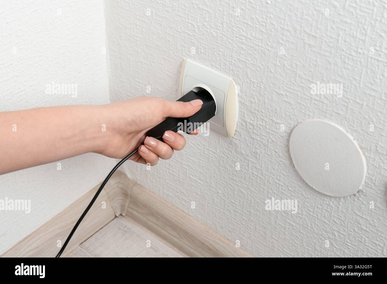Woman plugging USB power adapter with charge cable into electrical ...