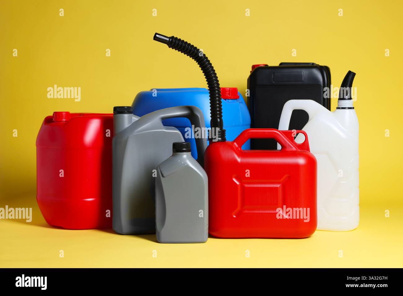 Many different plastic canisters on yellow background Stock Photo - Alamy