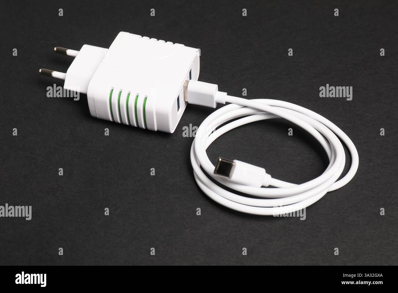 USB power adapter with charge cable on black background, closeup Stock ...