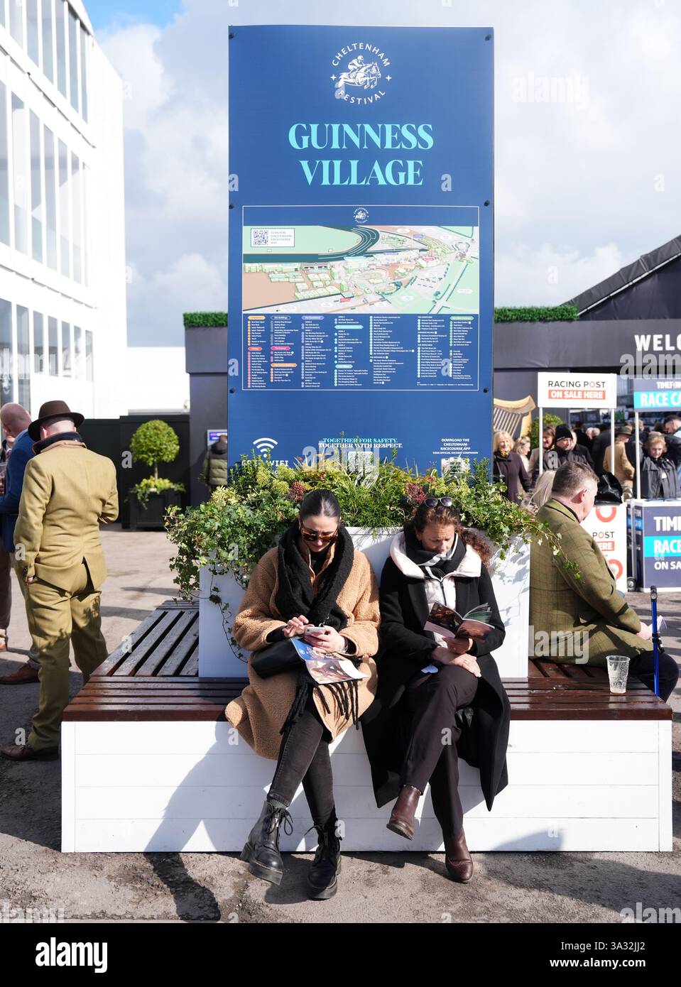 Racegoers check the form in the Guinness Village on day four of the ...