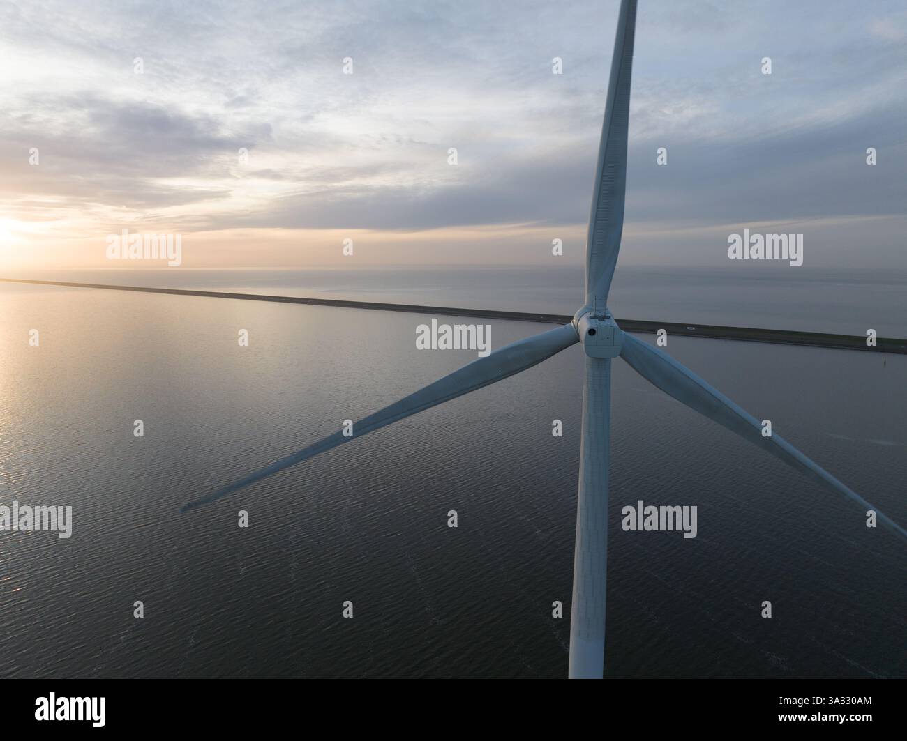 Wind turbine at sunset, offshore windpark, renewable energy, close up ...