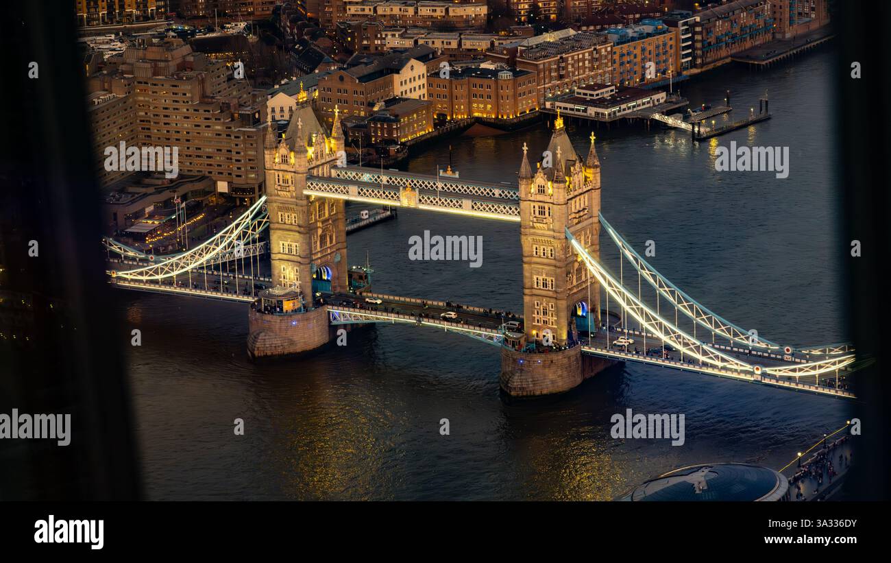Aerial view captures Tower Bridge illuminated in the evening ...