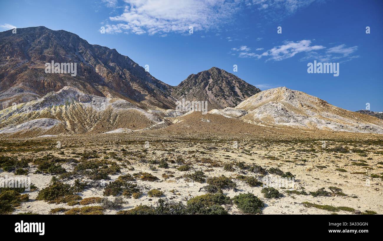 Vast desert-like landscape with volcanic rock and mountain range under ...