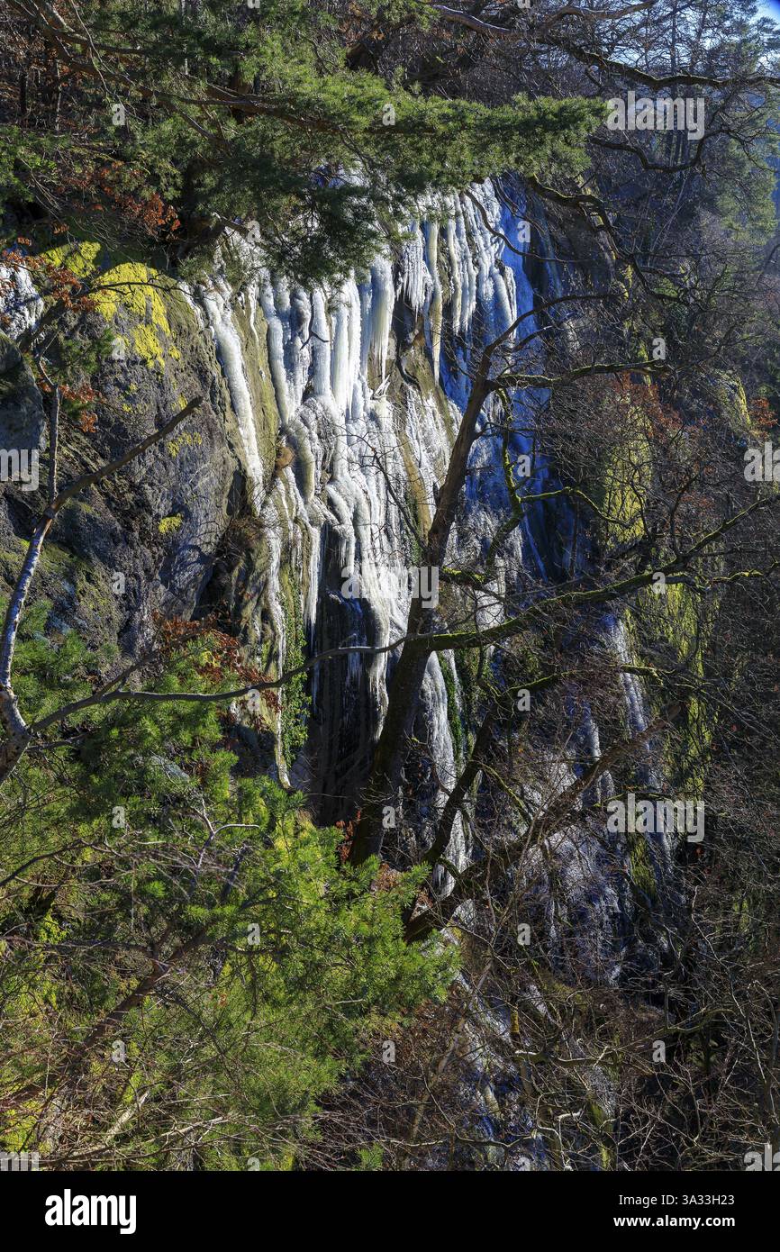 The moisture escaping from the sandstone freezes on the rock faces to form icicles and small ...