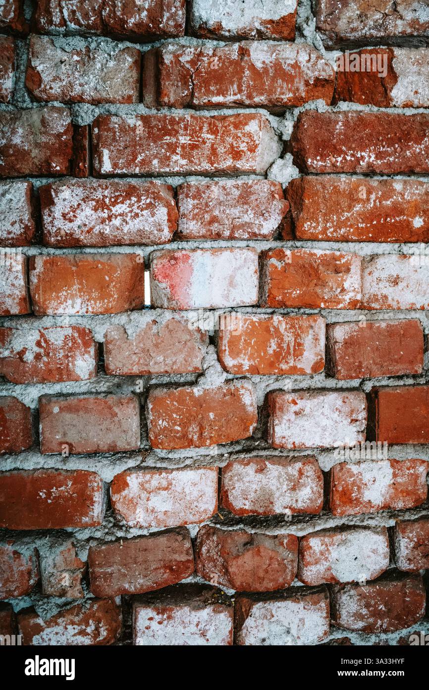 Old, run-down exterior brick wall texture with gray mortar stain. Close ...