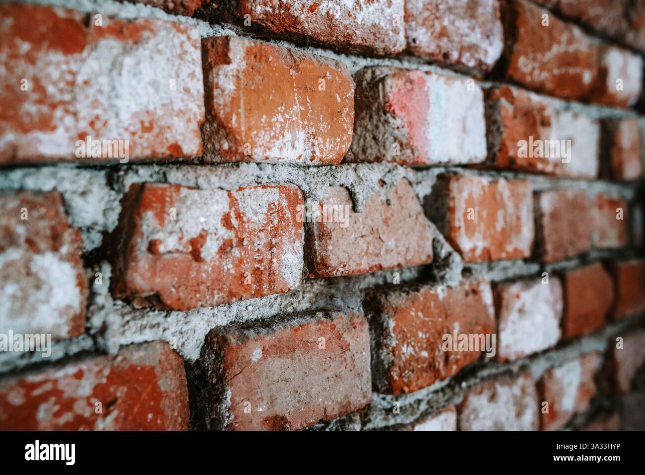 Old, run-down exterior brick wall texture with gray mortar stain. Close ...