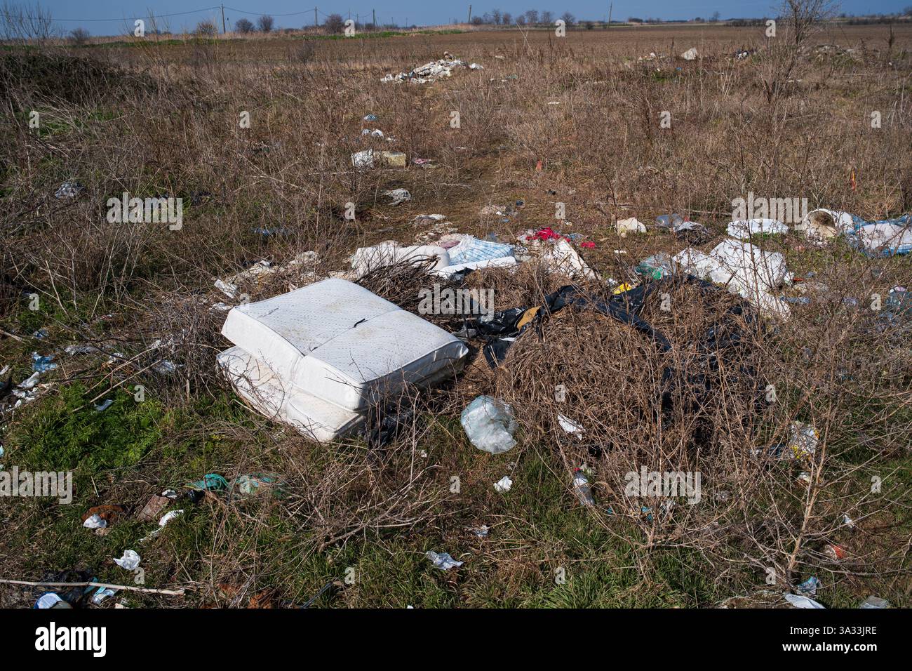 Illegal trash or garbage dumping on the side or a rural field, no ...