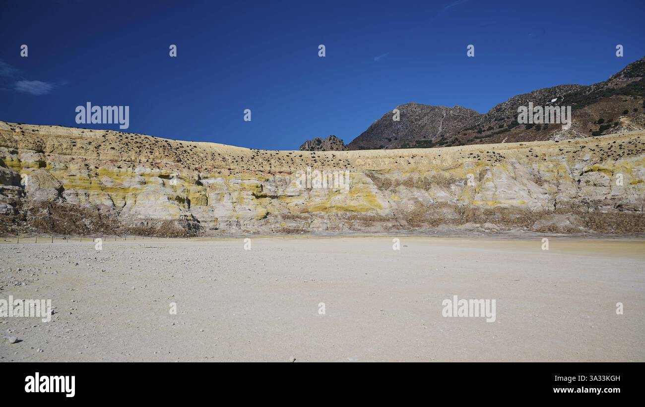 Wide, dry plain of a volcanic crater under a blue sky, volcanism ...