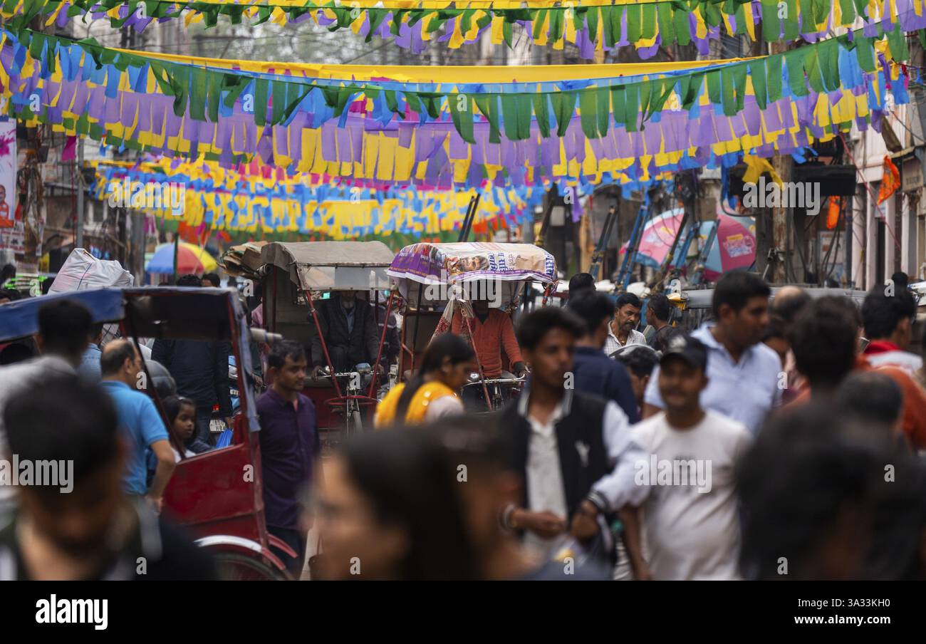 A crowded street in a market on the eve of Holi Festival, on March 13 ...
