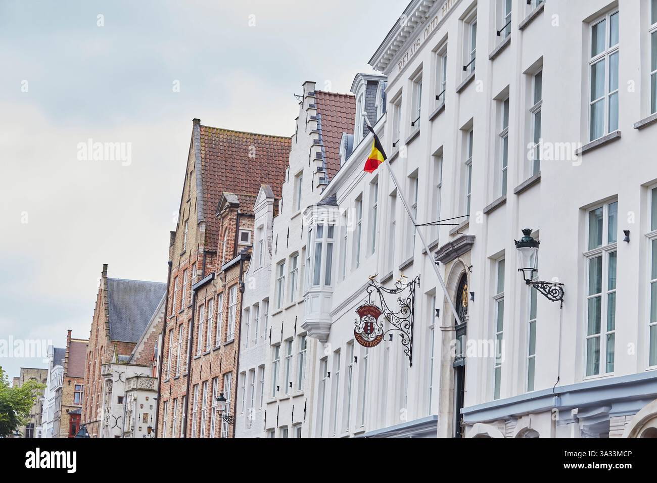 Traditional Belgian Architecture in the Heart of Bruges with flags ...