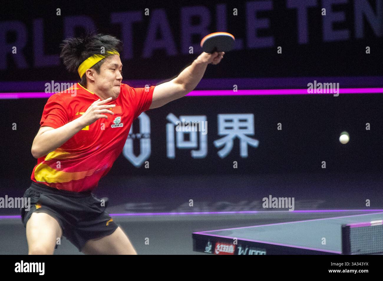 Chongqing, China. 14th Mar, 2025. Wang Chuqin hits a return during the ...