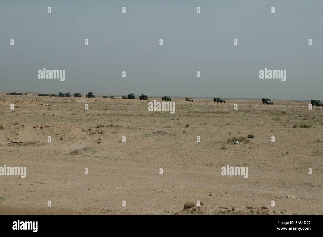 Mar 04, 2004; Western Iraq, Iraq; In the distance, a convoy of 1st ...
