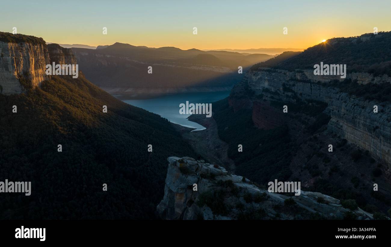 A breathtaking view of the Panta de Sau Reservoir at sunset, surrounded ...
