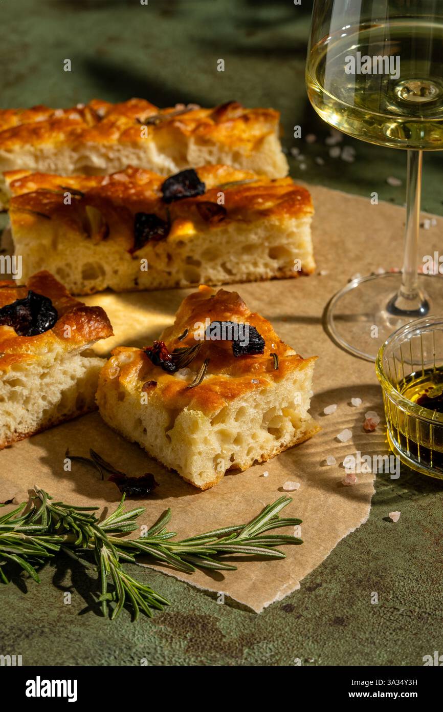 Golden homemade focaccia slices topped with sun dried tomatoes and ...