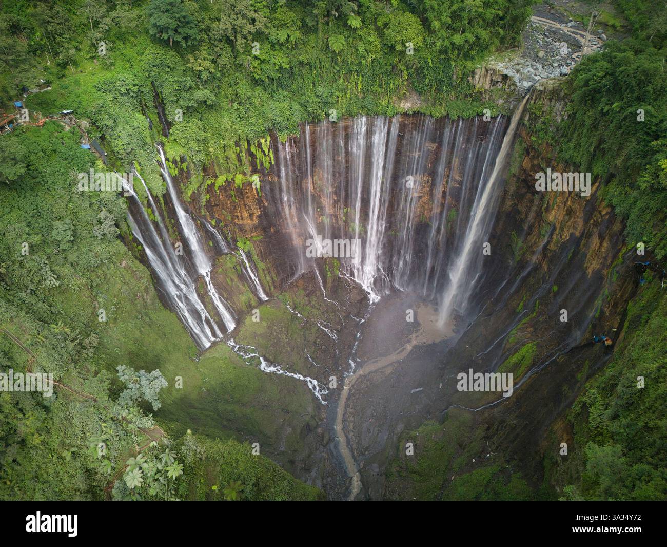An aerial shot captures the stunning Tumpak Sewu Waterfall in full ...