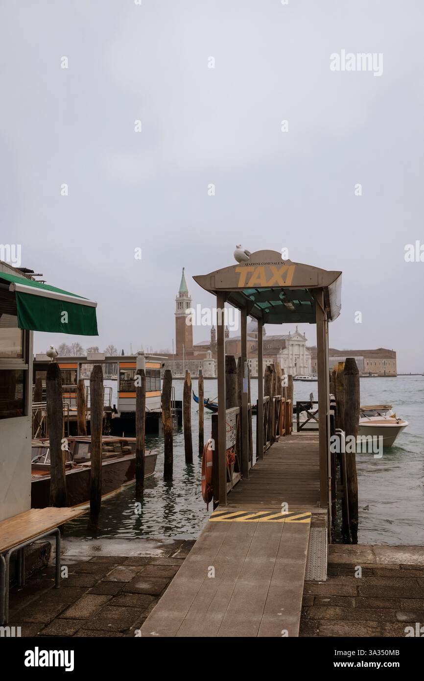 A serene view of a water taxi dock in Venice, Italy. The iconic lagoon ...