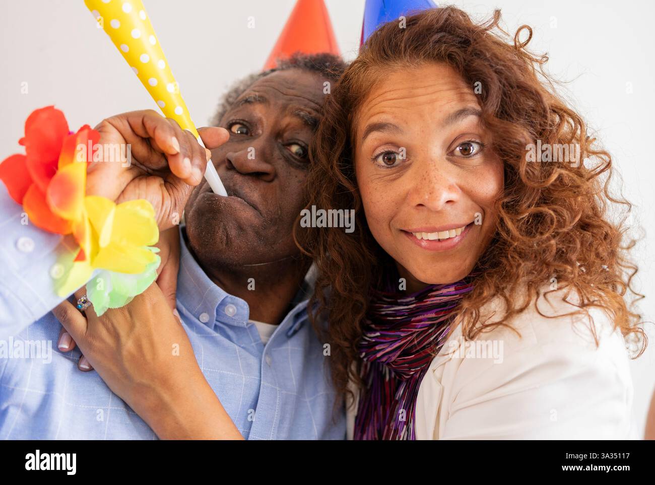 A joyful moment at a birthday celebration featuring two people wearing ...