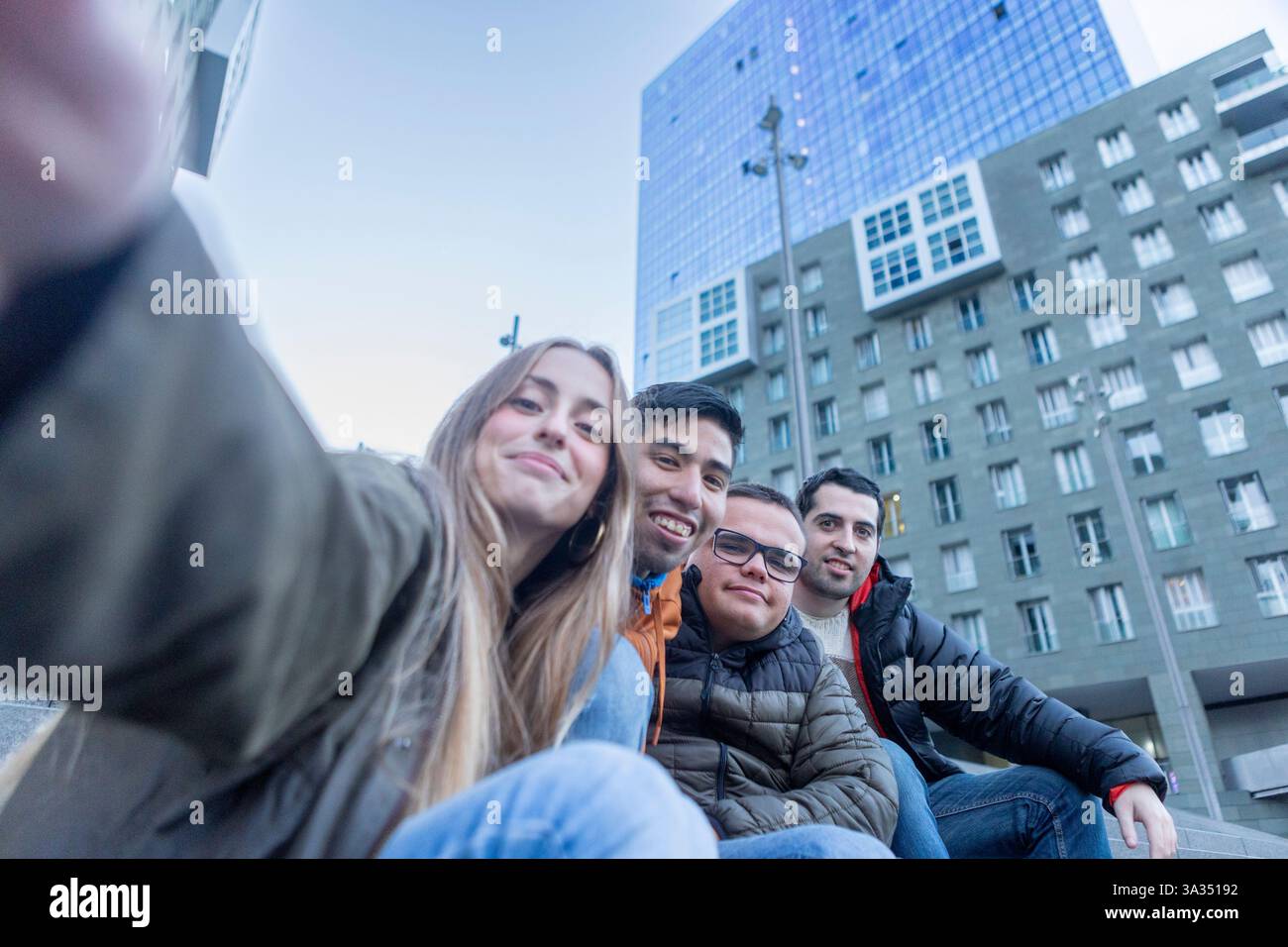 A caregiver and three young men with intellectual disabilities take a ...