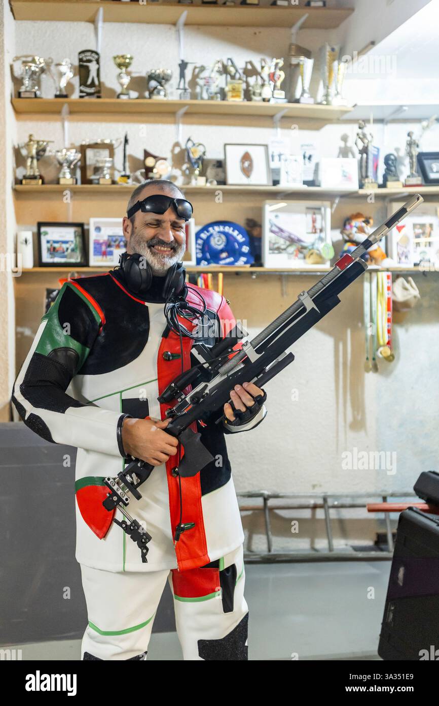 A blind shooter in action, wearing a specialized suit and holding a ...