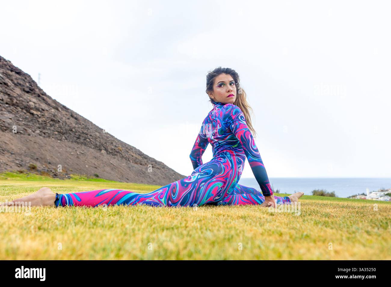 A woman performs an expressive dance pose outdoors, embracing LGBTQIA+ ...