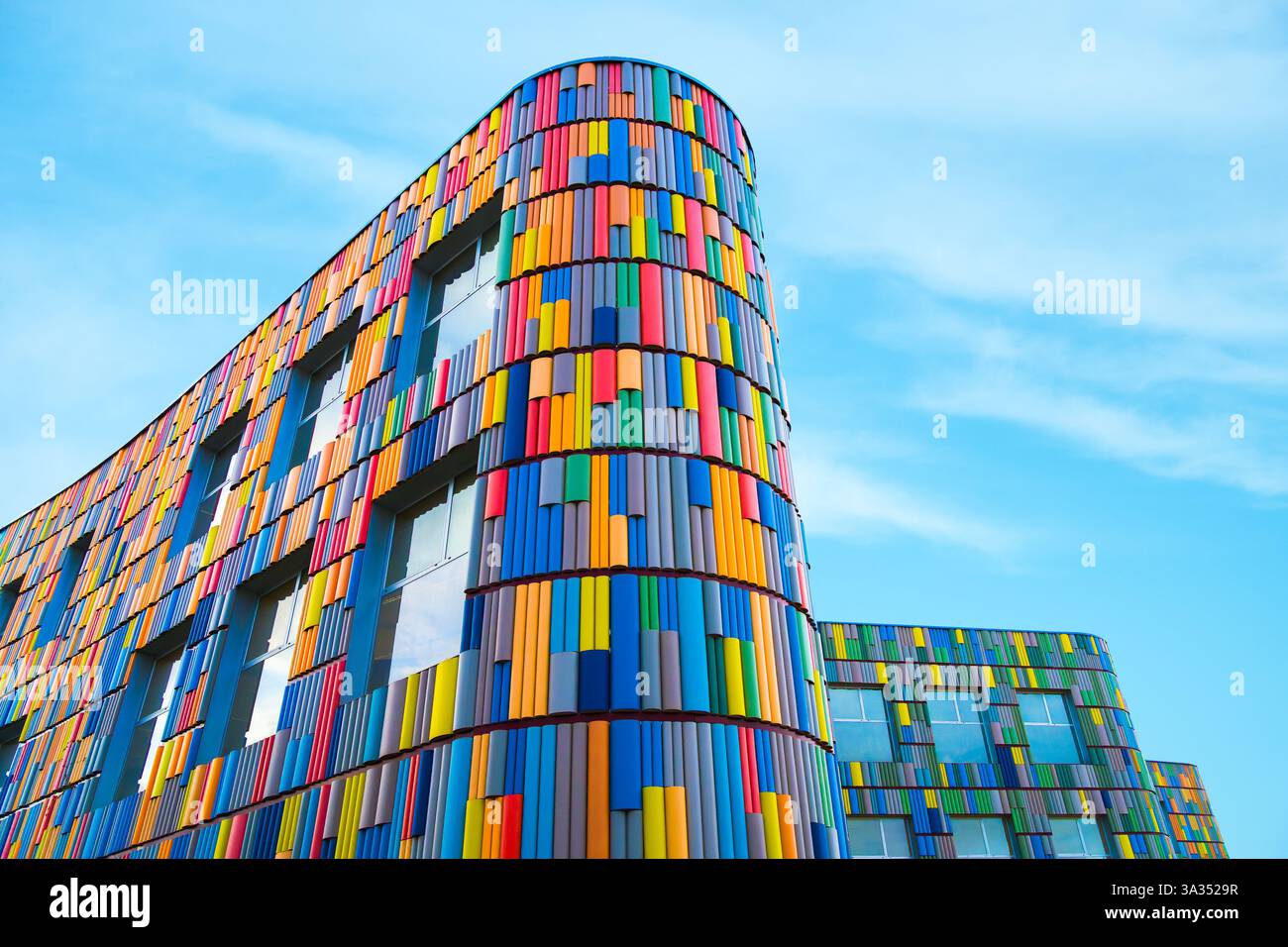 Low angle of a vibrant multicolor facade adorns a modern curved ...
