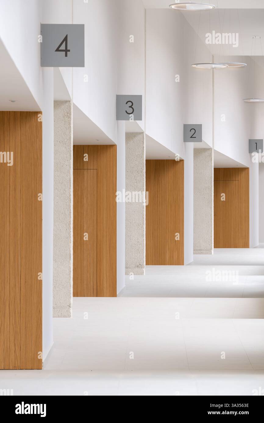 A serene view inside a building featuring minimalist design with white ...