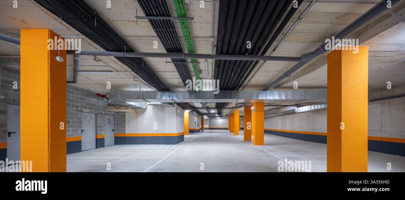 A modern parking garage featuring bright orange pillars, streamlined ...