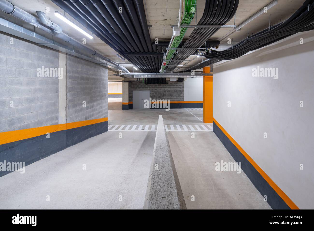 This image showcases a well-lit, modern underground parking garage with ...
