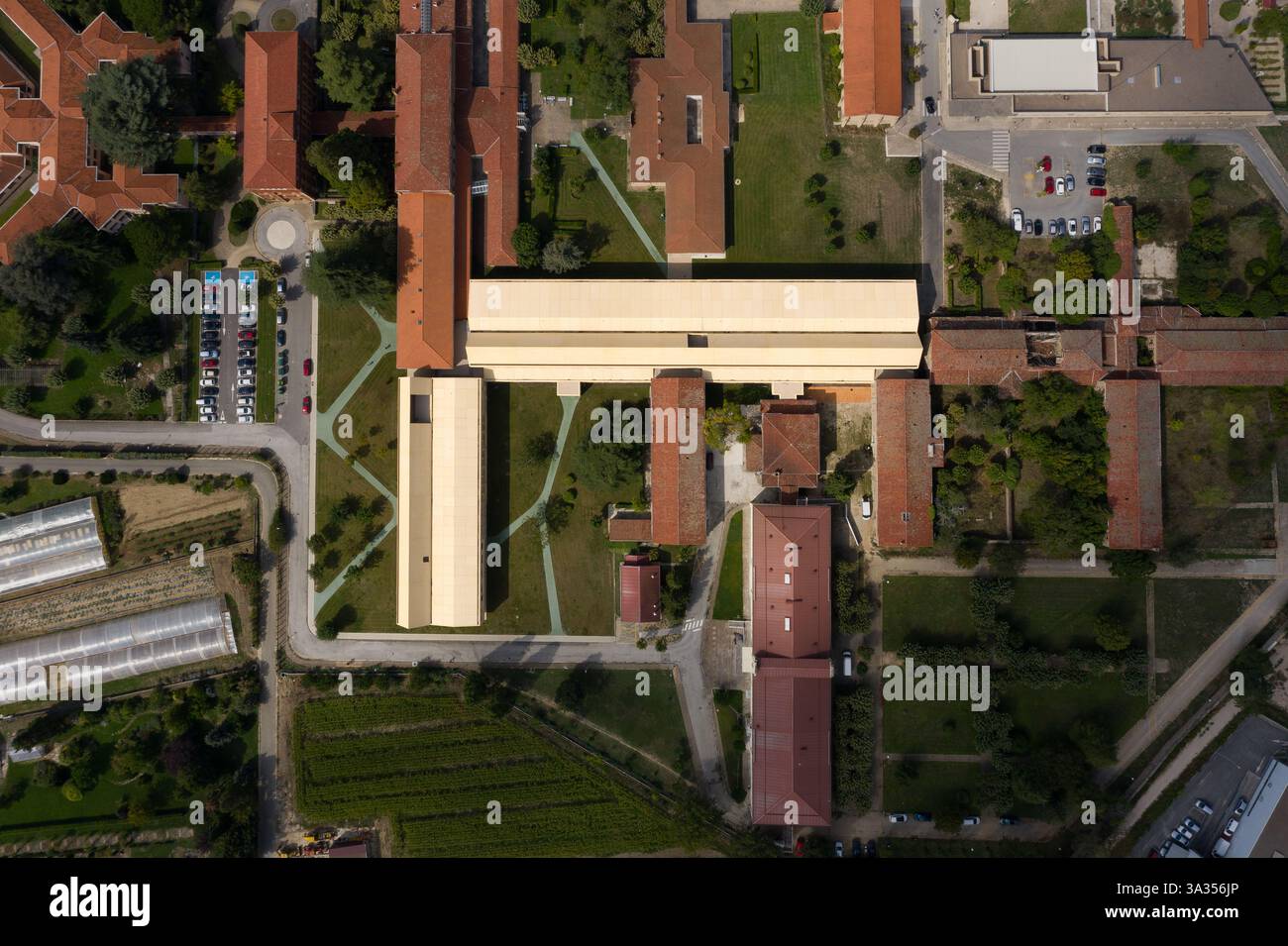 Aerial view of a hospital featuring red roofed, green spaces, parking ...