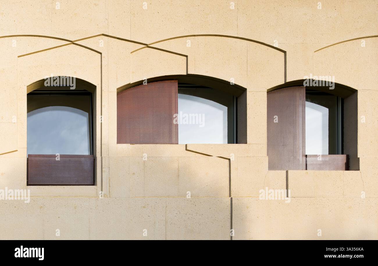 Close up of a modern hospital facade featuring three arched windows ...
