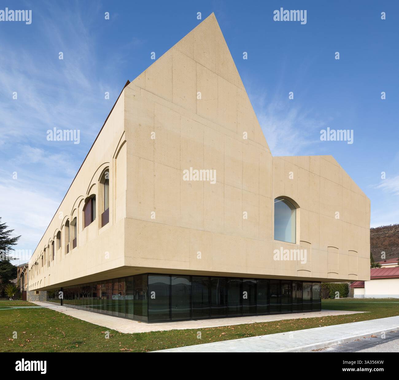 A modern angular hospital with a unique beige exterior and glass ...