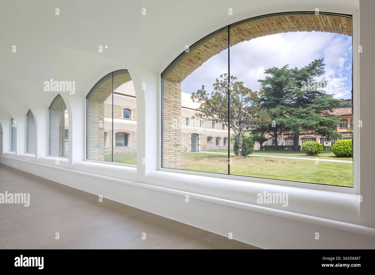View os hospital through elegant arched windows in a bright corridor ...