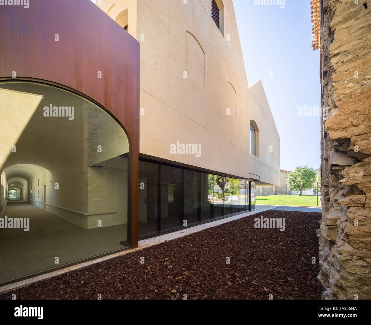 A contemporary hospital with smooth lines and large glass windows ...