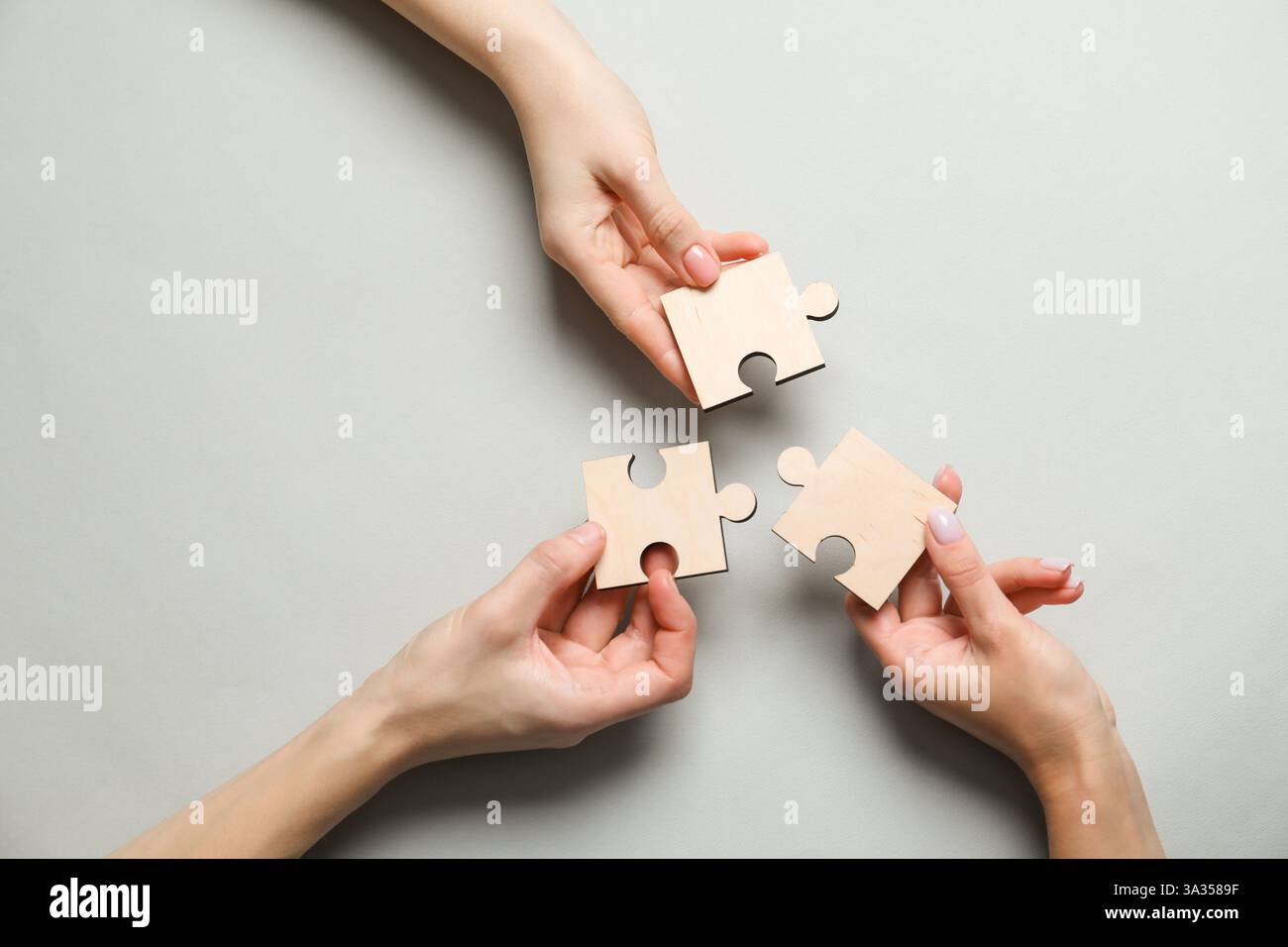 Business strategy and teamwork concept. Partners with different puzzle ...