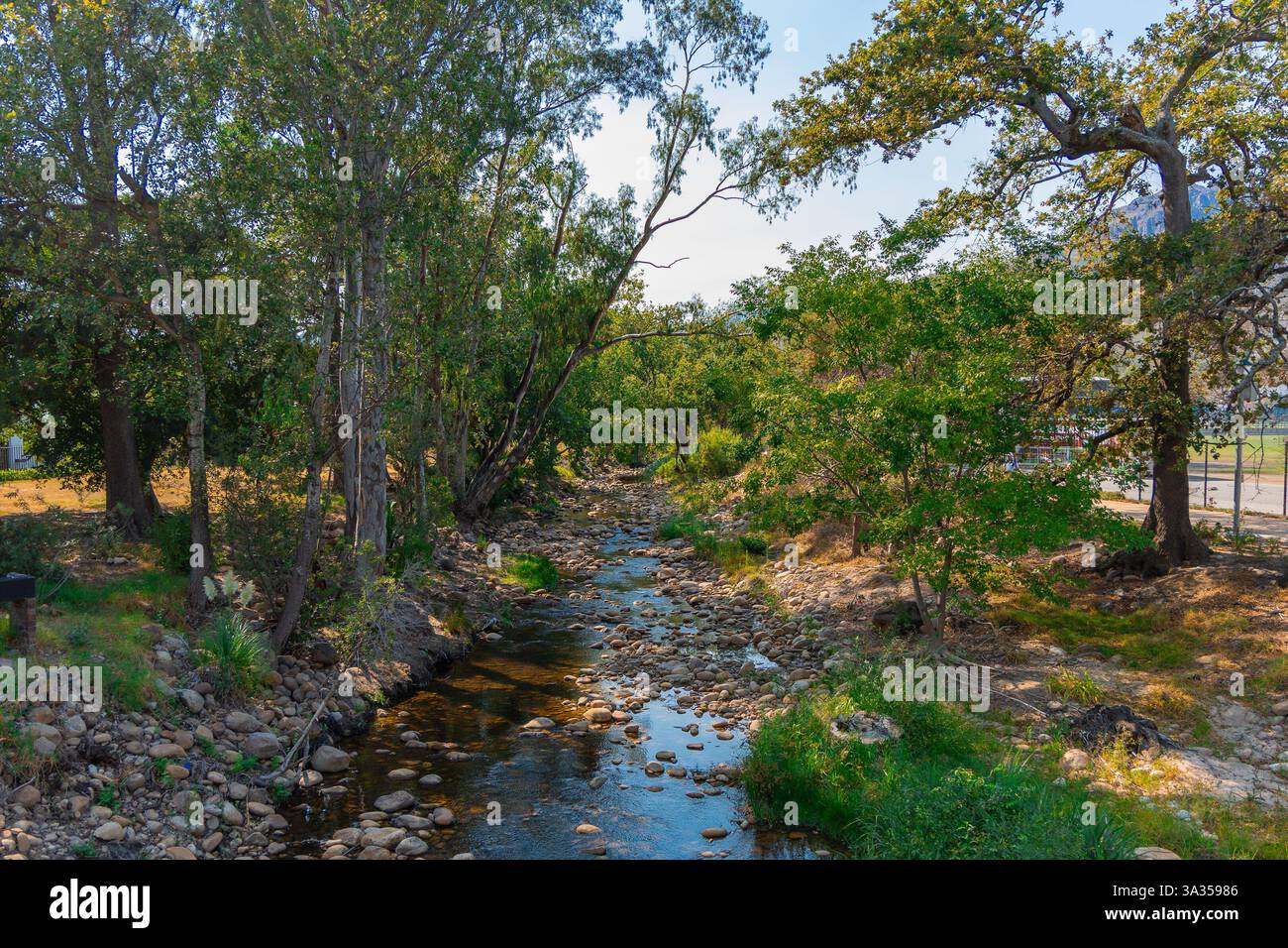Eerste river in stellenbosch slowly moving downstream over round rocks ...